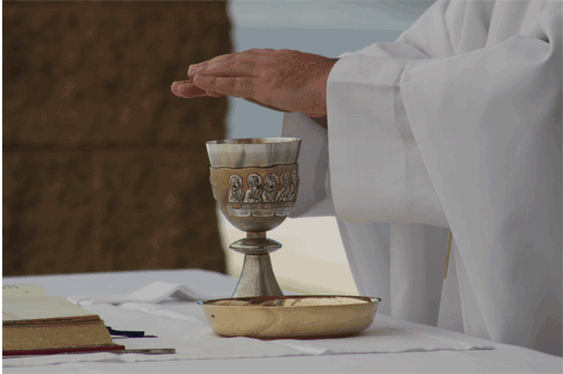 hands-over-cup-and-host